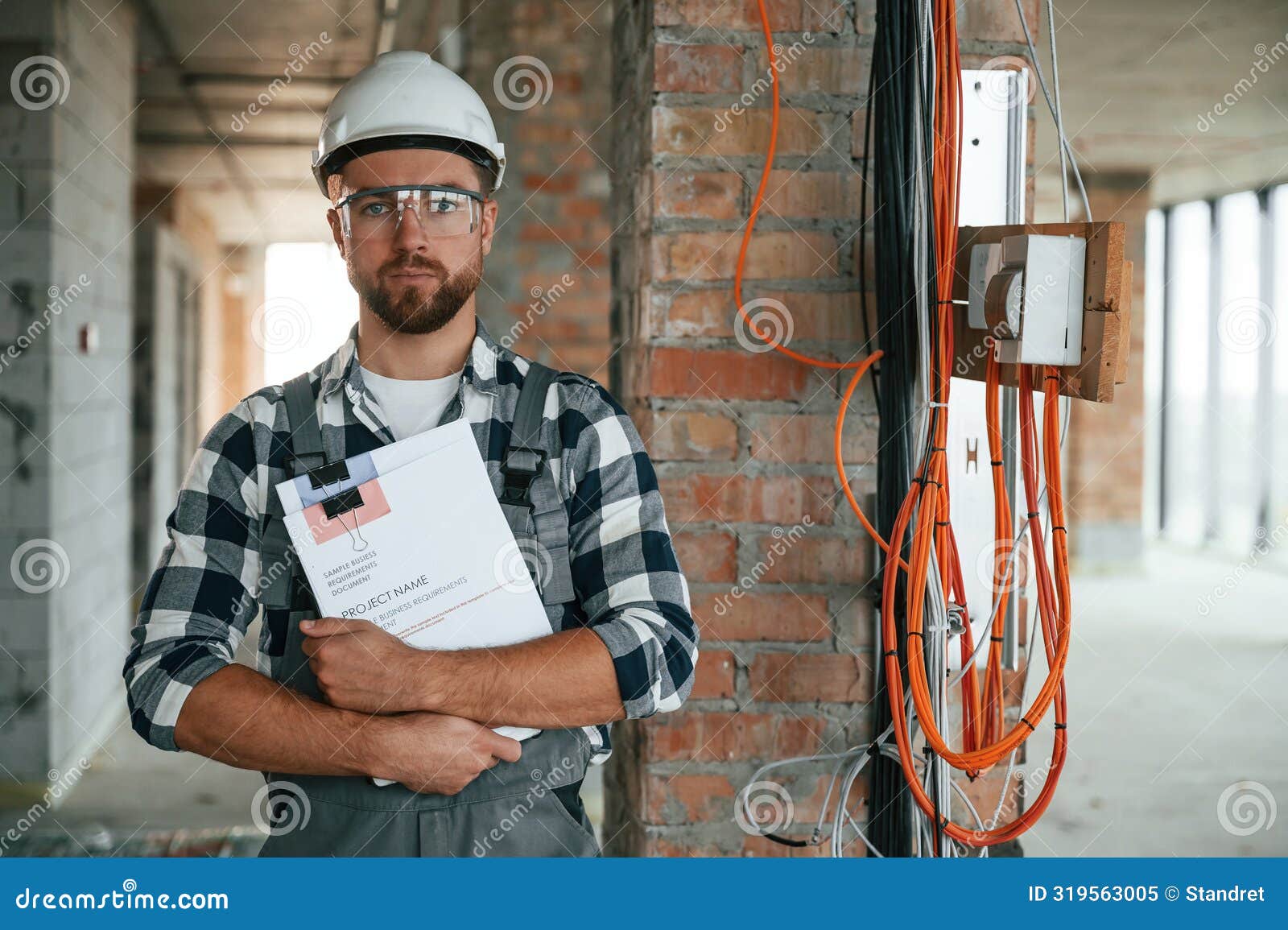 Electrician with Notebook. Construction Worker in Uniform in Empty ...