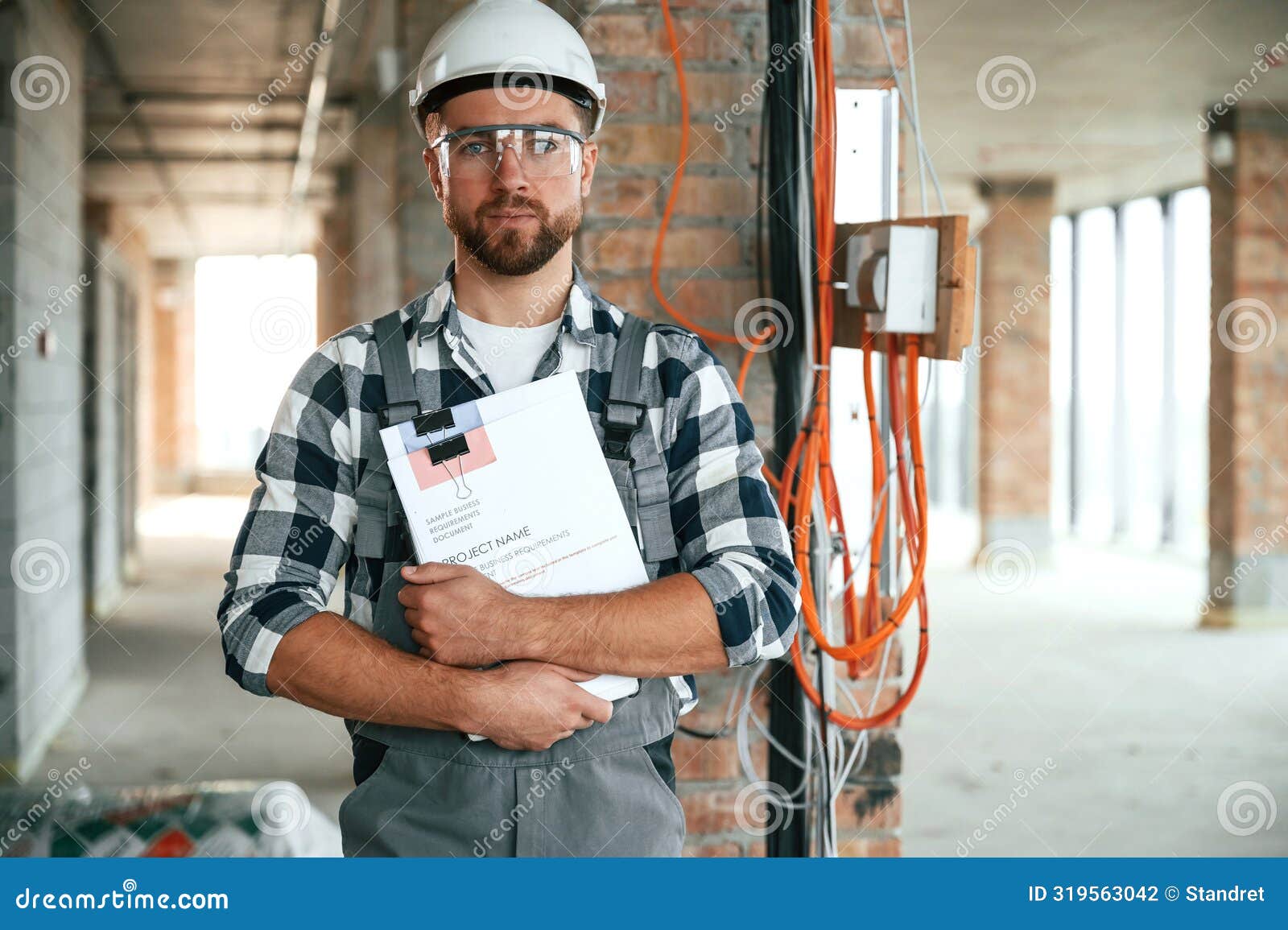 Electrician with Notebook. Construction Worker in Uniform in Empty ...