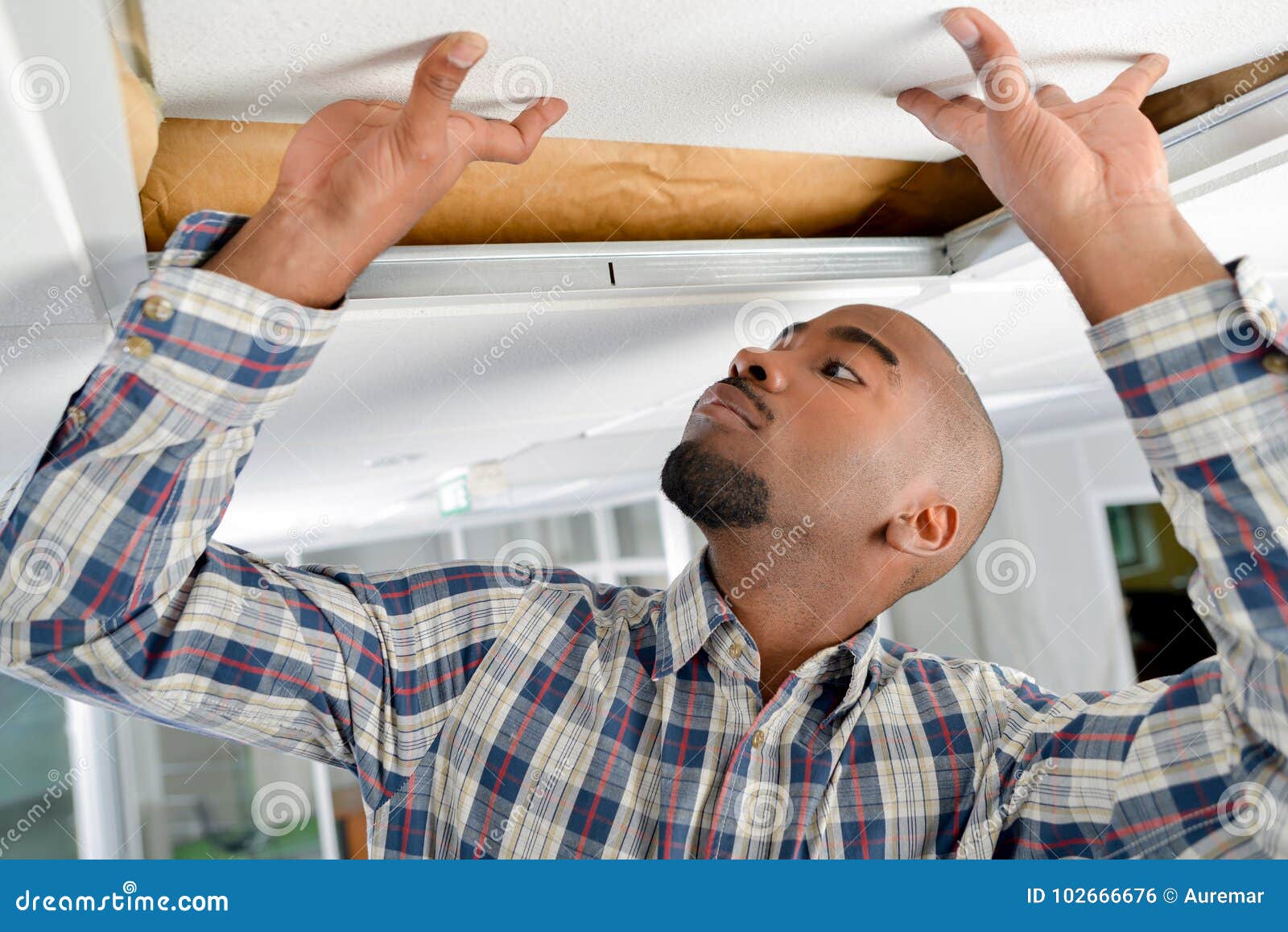 Electrician Peeking Under Ceiling Tile Stock Photo - Image of peeking ...