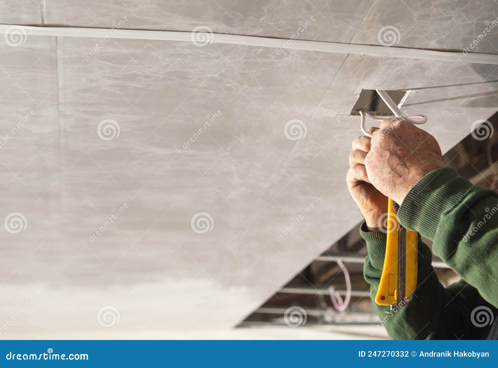 Electrician Performs Electric Installation on the Ceiling of a House ...
