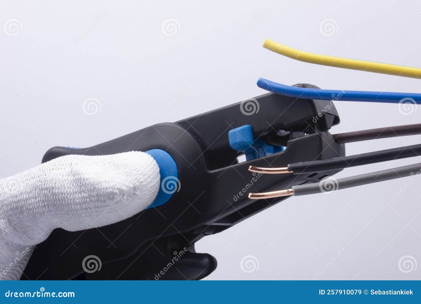 An Electrician Prepares the Cable for Connection, Removes the ...