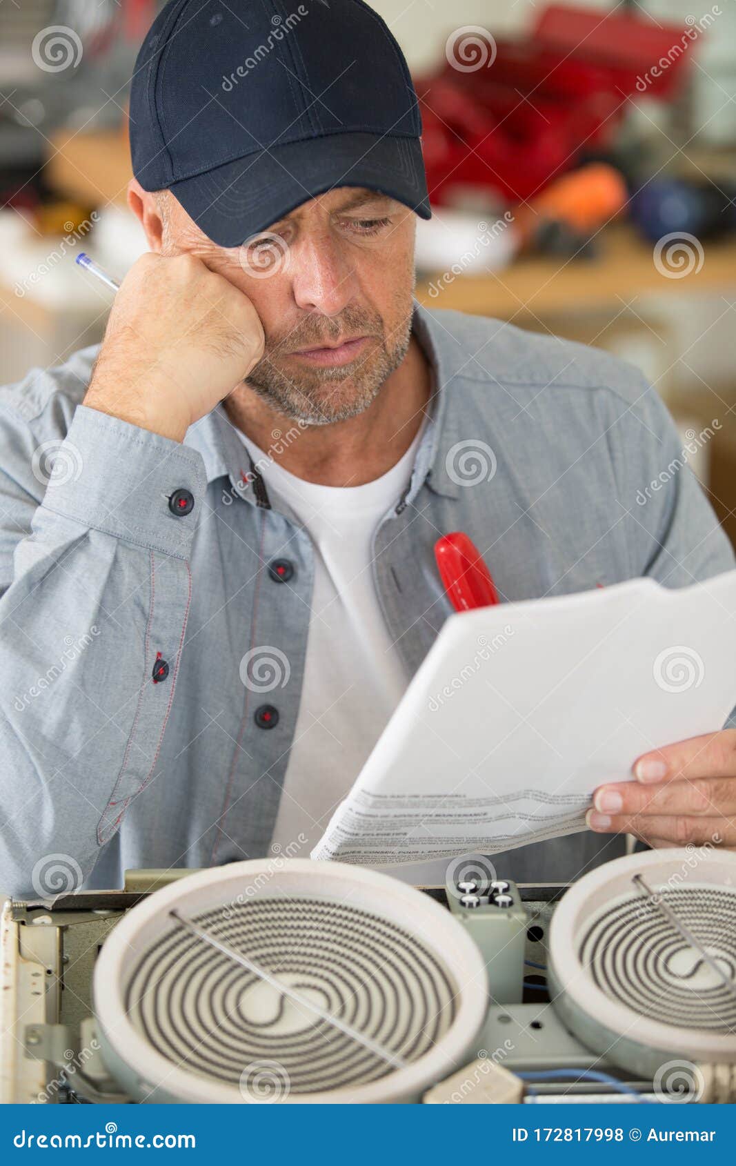 Electrician Reading Instructions while Working on Appliance Stock Photo ...