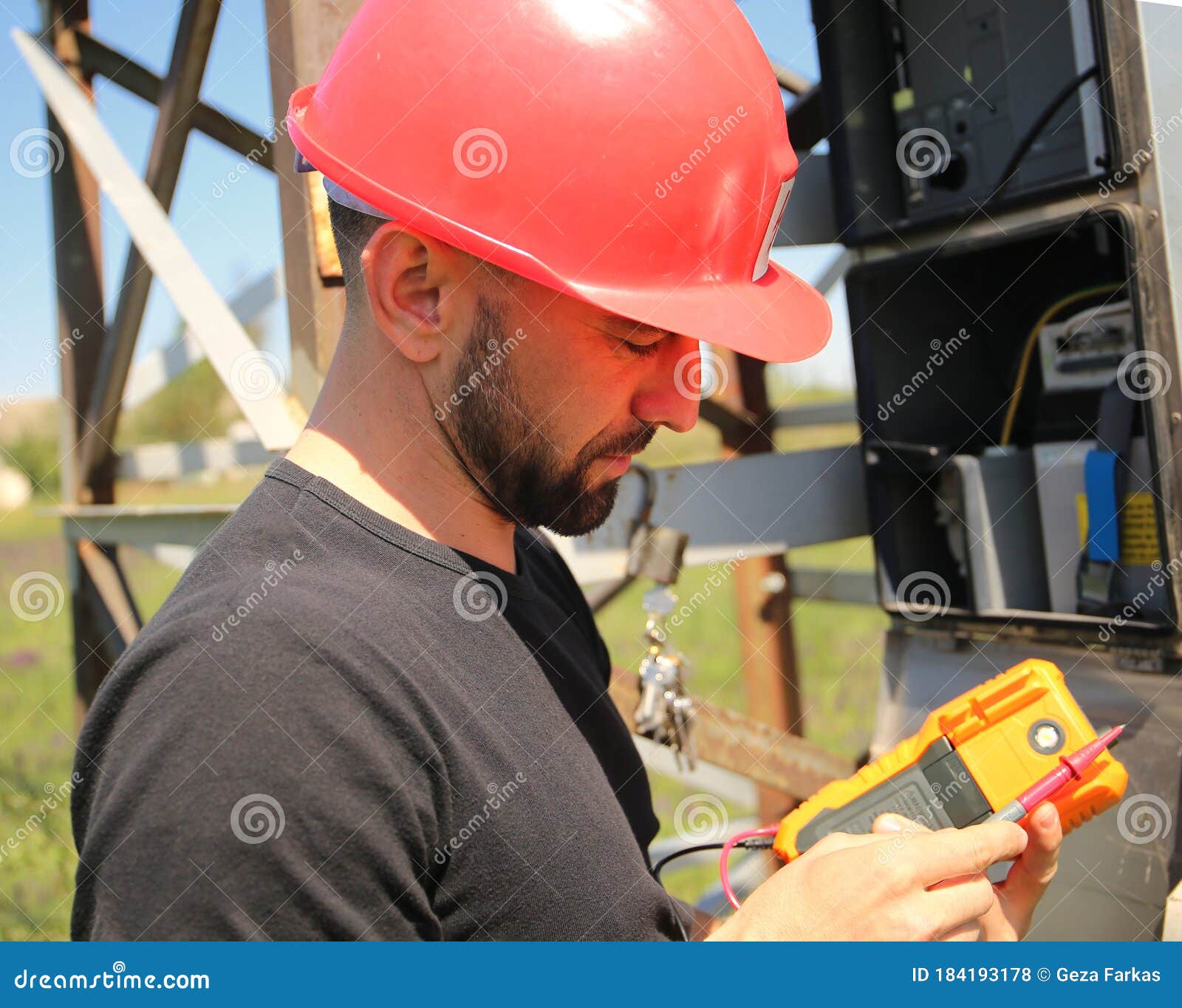 Electrician in Red Helmet with Multimeter Stock Photo - Image of ...