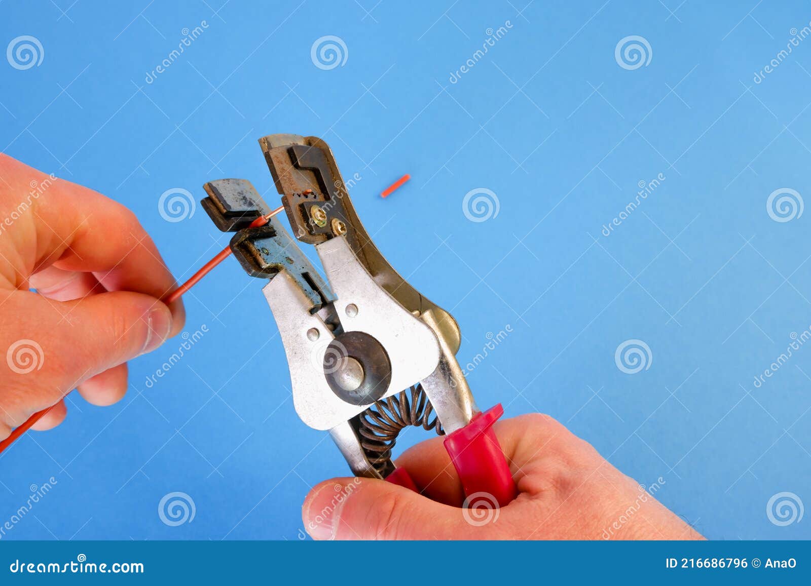 The Electrician Removes the Insulation from the Wire Using a Special ...