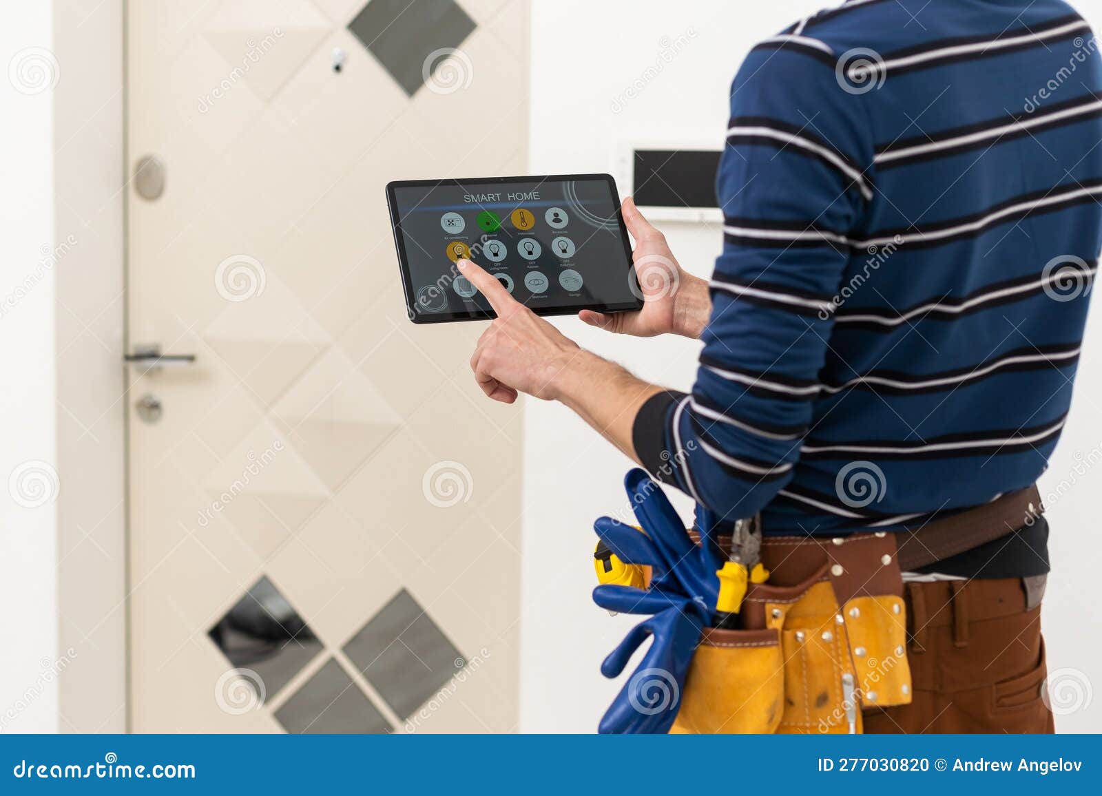 An Electrician Repairs an Intercom with a Tablet Stock Photo - Image of ...