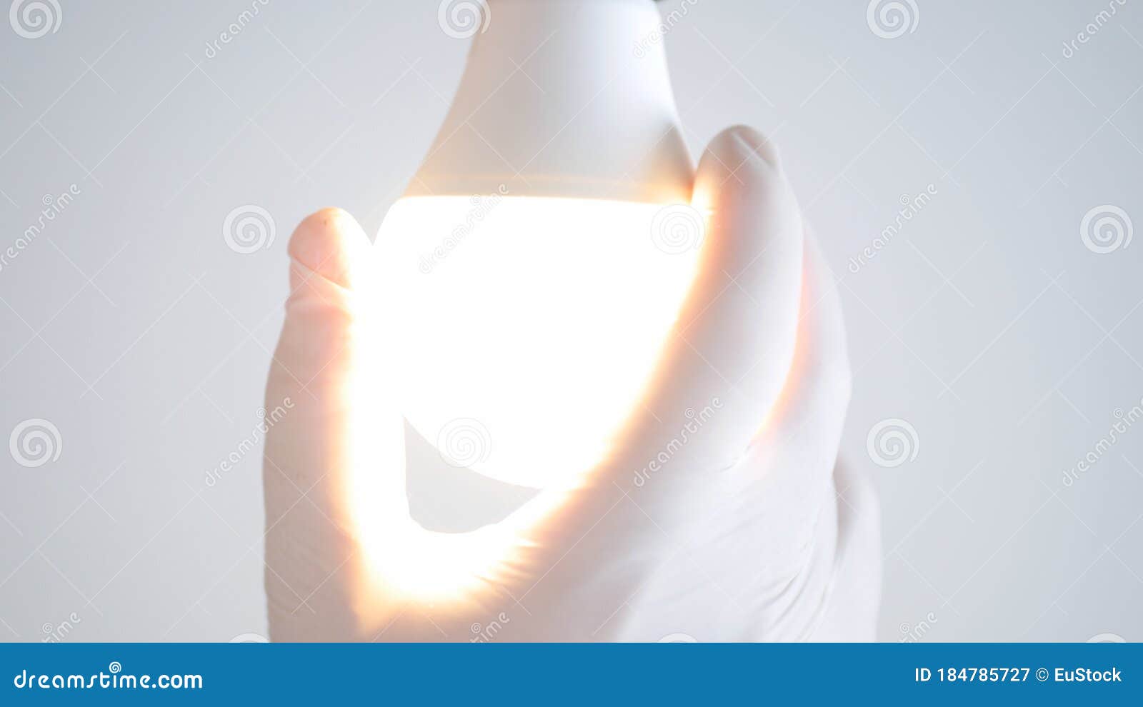 Electrician`s Hand Rotates a Led Bulb in Electrical Socket Turning on ...