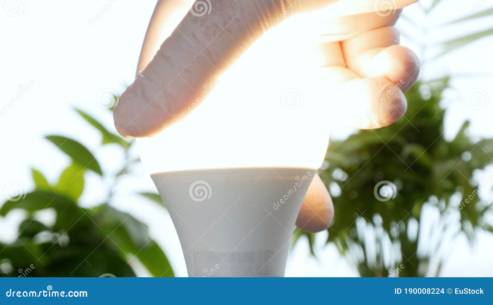 Electrician`s Hand Rotates A Led Bulb In Electrical Socket Turning On ...