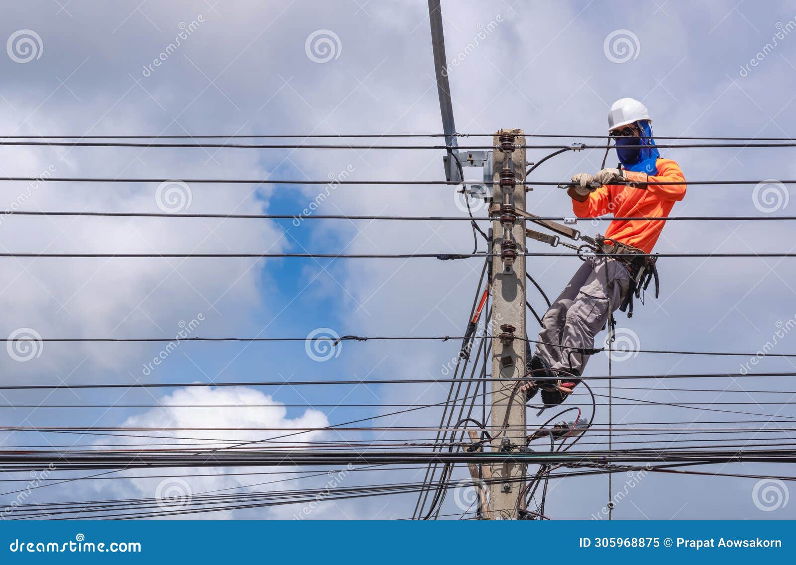 Electrician with Safety Equipment and Various Work Tools Installing ...