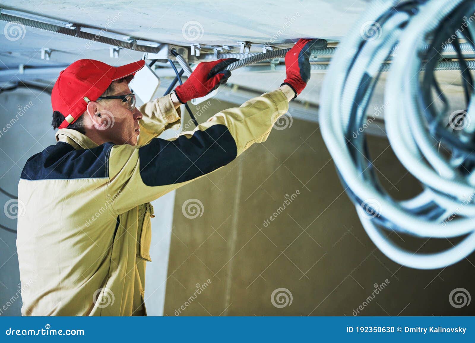 Electrician Service. Installer Nailing Tube Holder For Cable Conduit ...