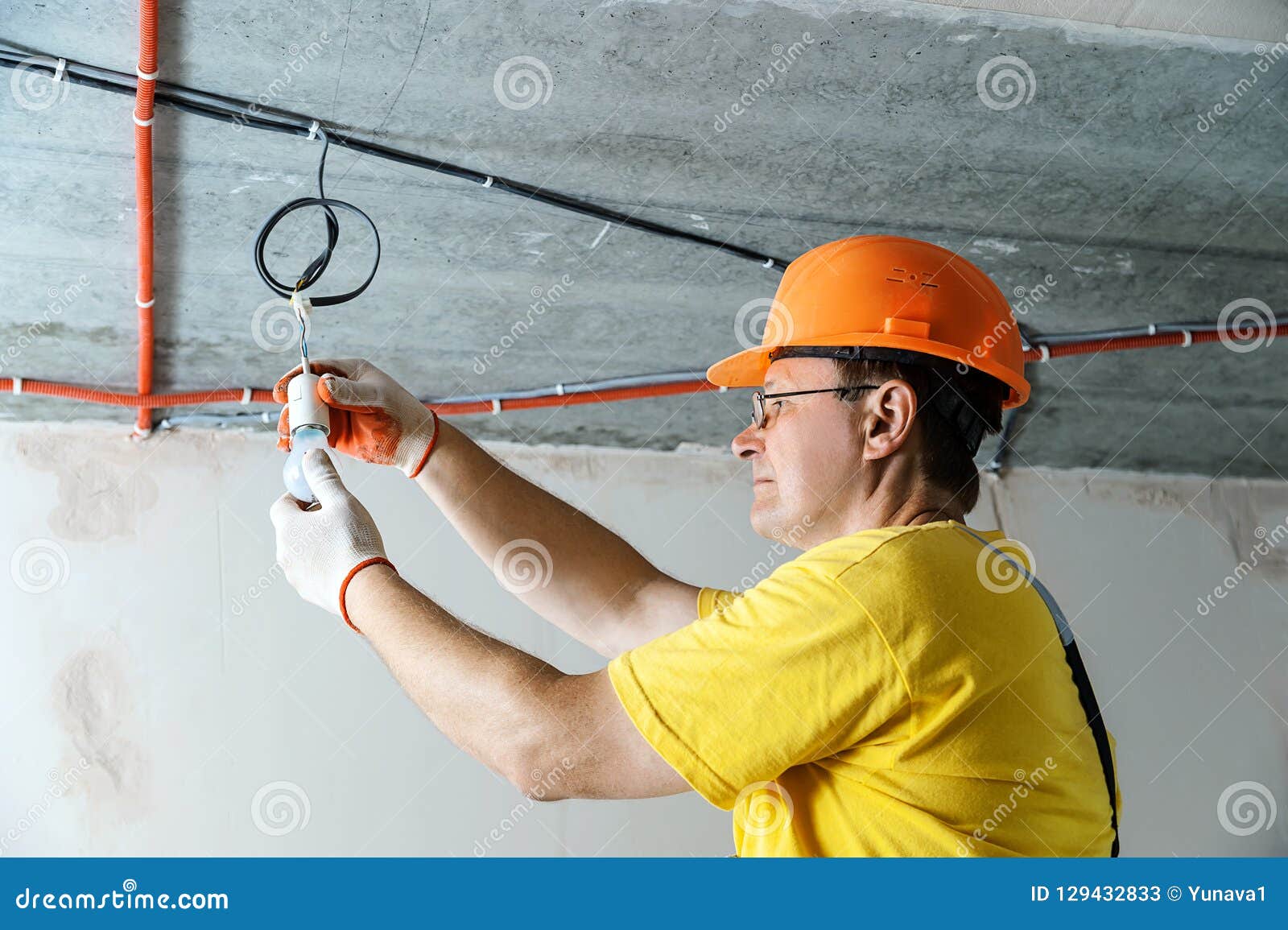 The Electrician is Setting a Bulb. Stock Image - Image of lighting ...