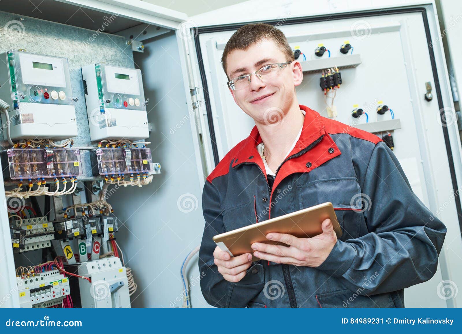 Electrician Smiling Near Switch Box with Tablet Computor Stock Image ...