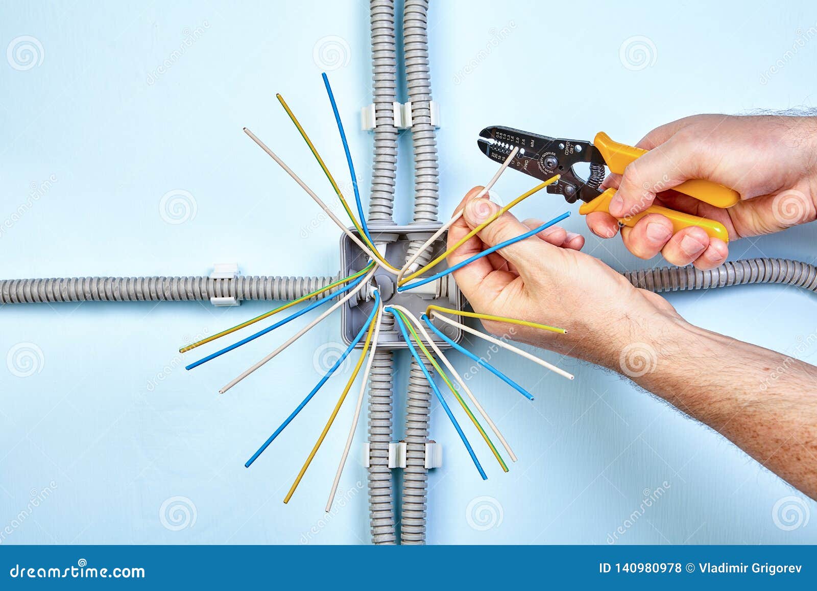 An Electrician Strips Electrical Wires. Yellow Wire Cutters Strip The ...