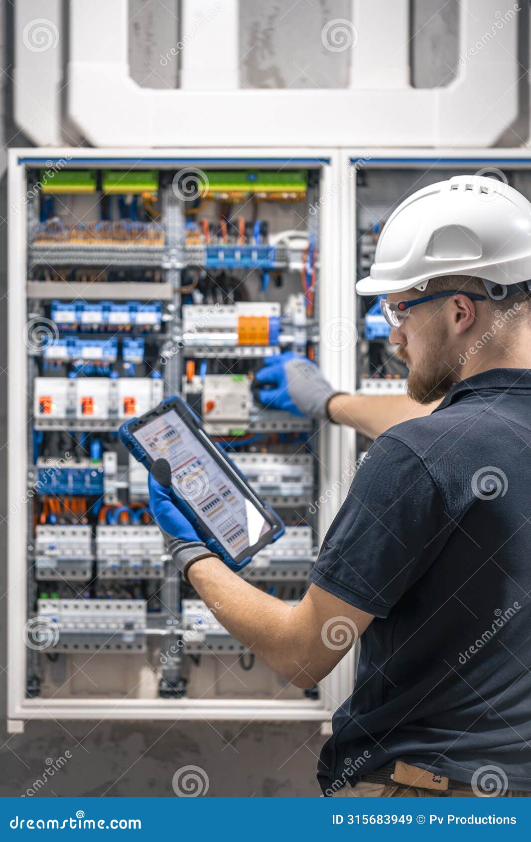 Electrician with Tablet Adjusting Circuitry at Junction Box. Stock ...