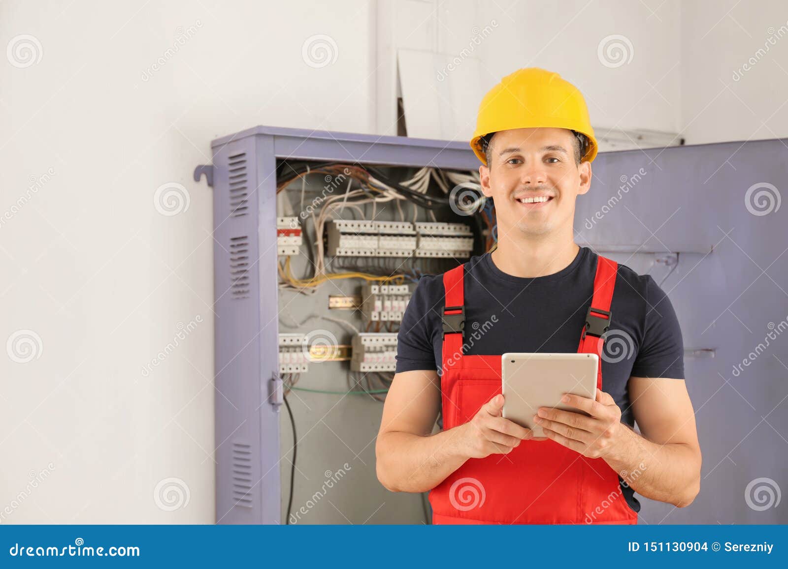 Electrician with Tablet PC Near Distribution Board Indoors Stock Photo ...