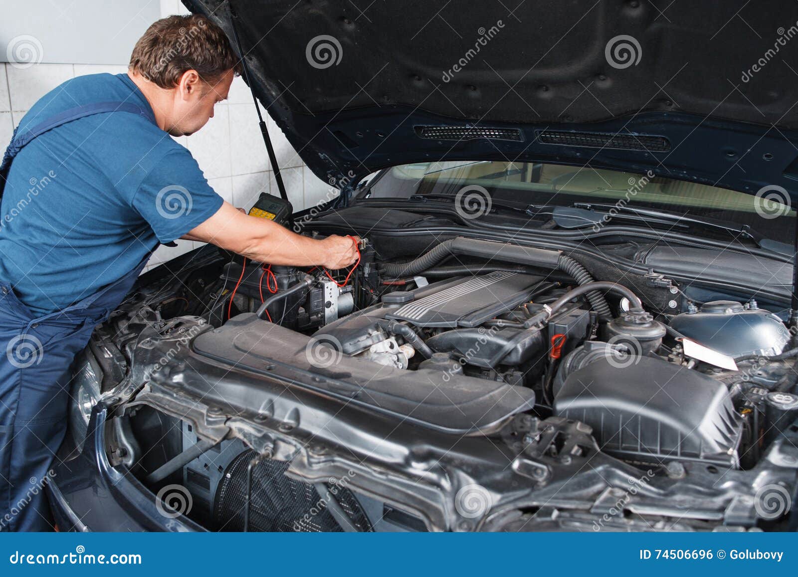 Electrician Testing Car with Multimeter at Garage Stock Photo - Image ...