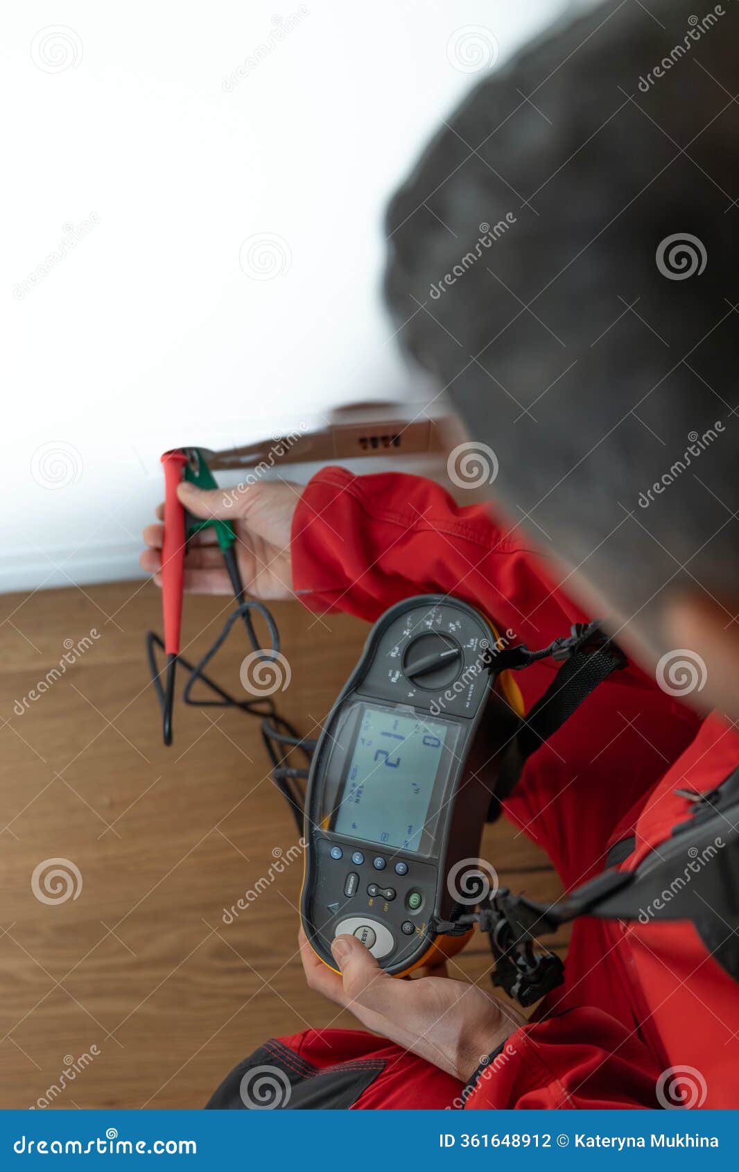 An Electrician Tests An Exposed Grounded Wire With A Digital Multimeter ...