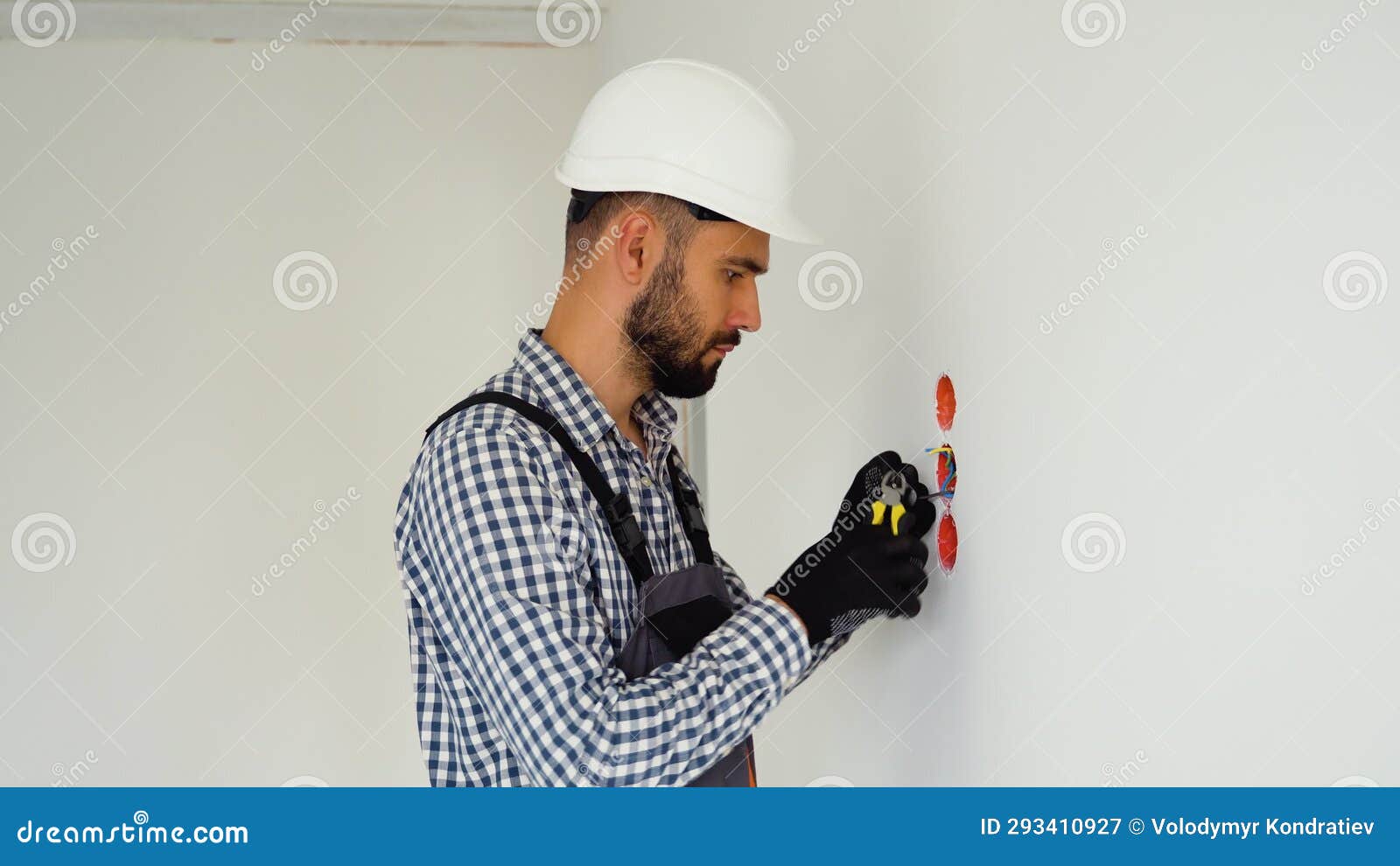 Electrician in Uniform Using Pliers while Replacing a Socket in ...