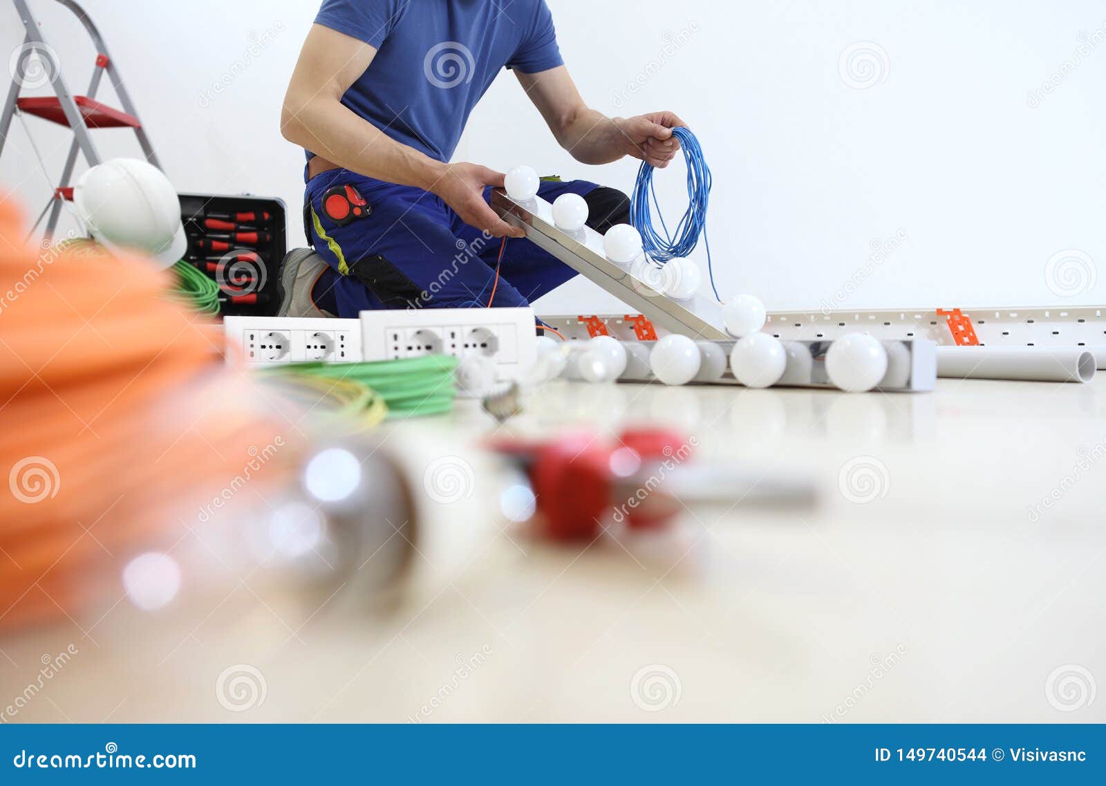 Electrician at Work Installing Lamp, with Cable in Hand, Install ...