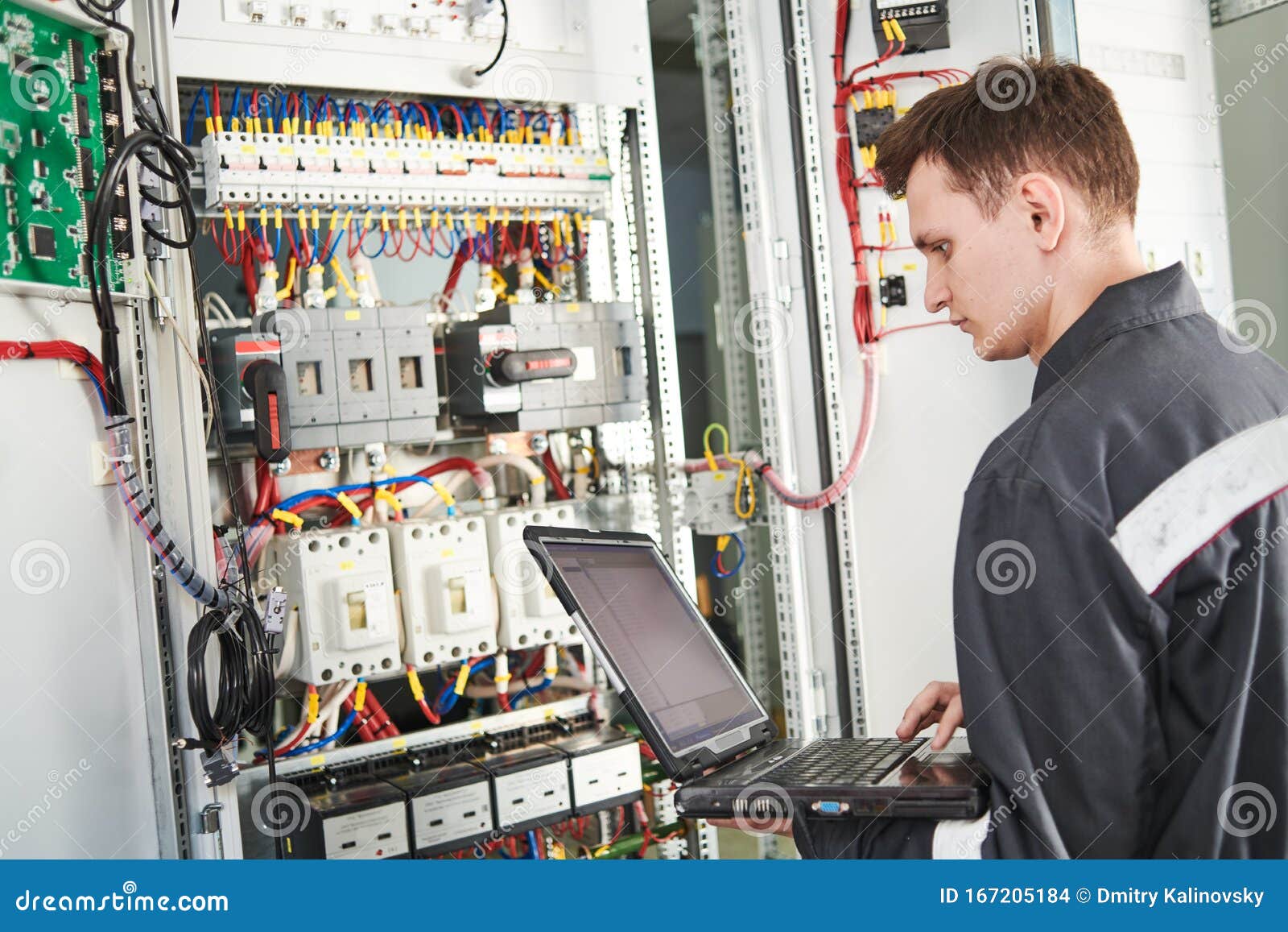 Electrician Works with Laptop Computer in Switchbox Stock Photo - Image ...