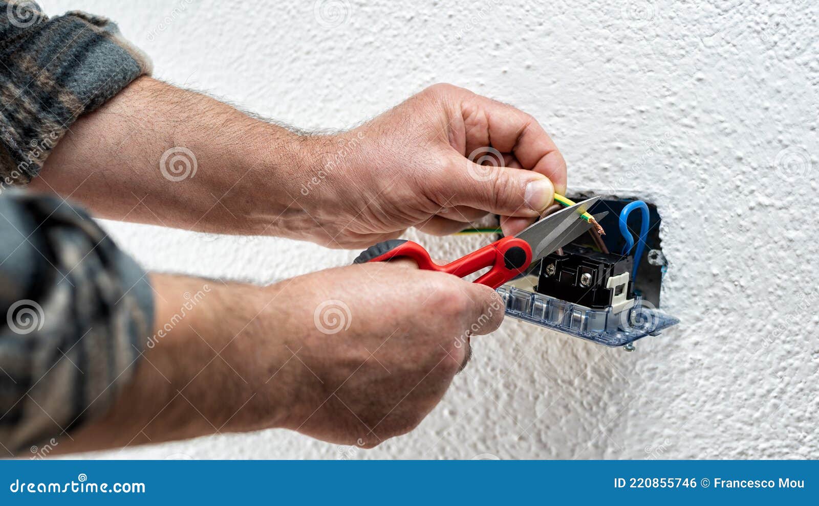 Electrician at Work on a Residential Electrical System. Electricity ...