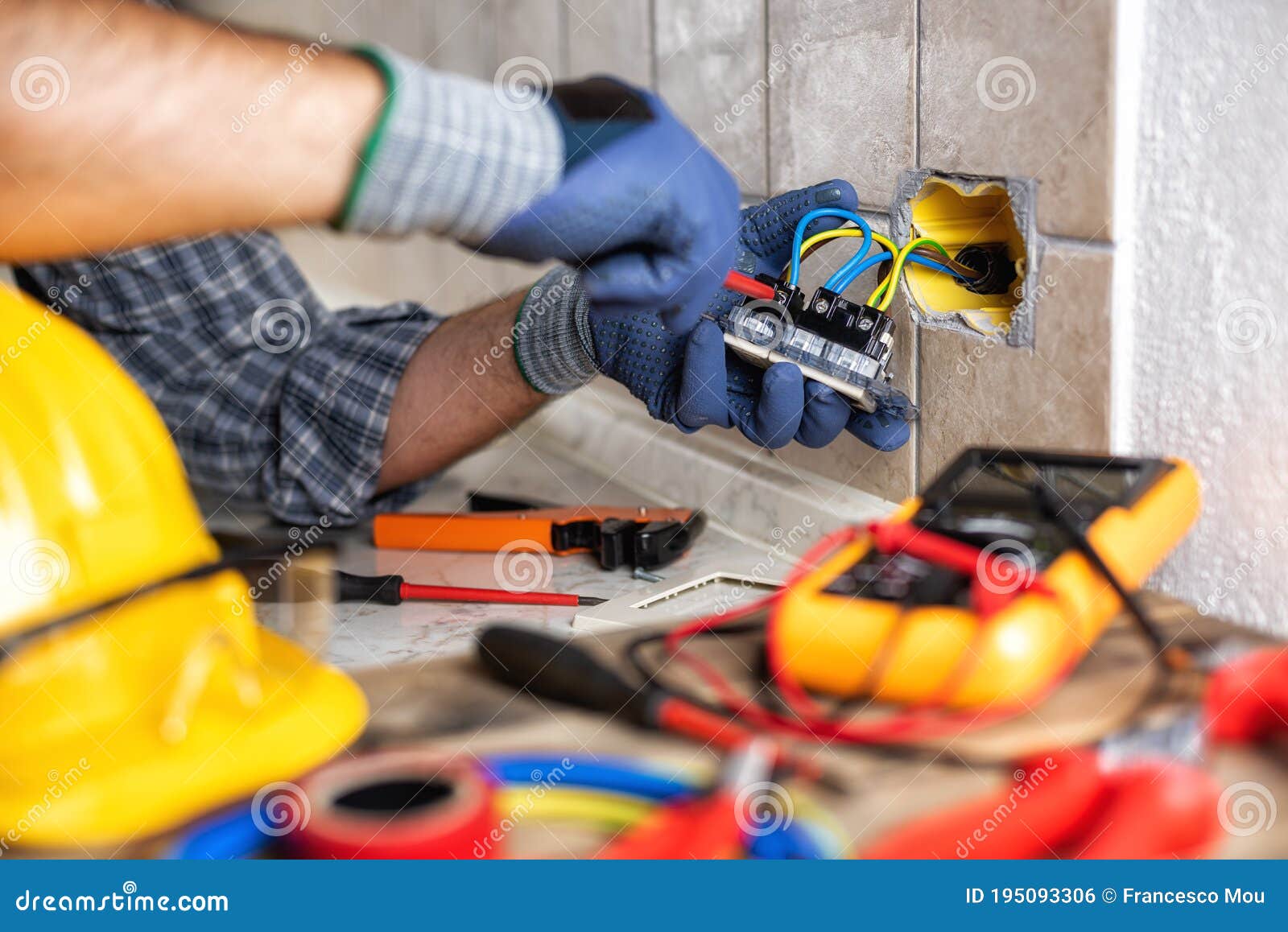 Electrician at Work with Safety Equipment on a Residential Electrical ...