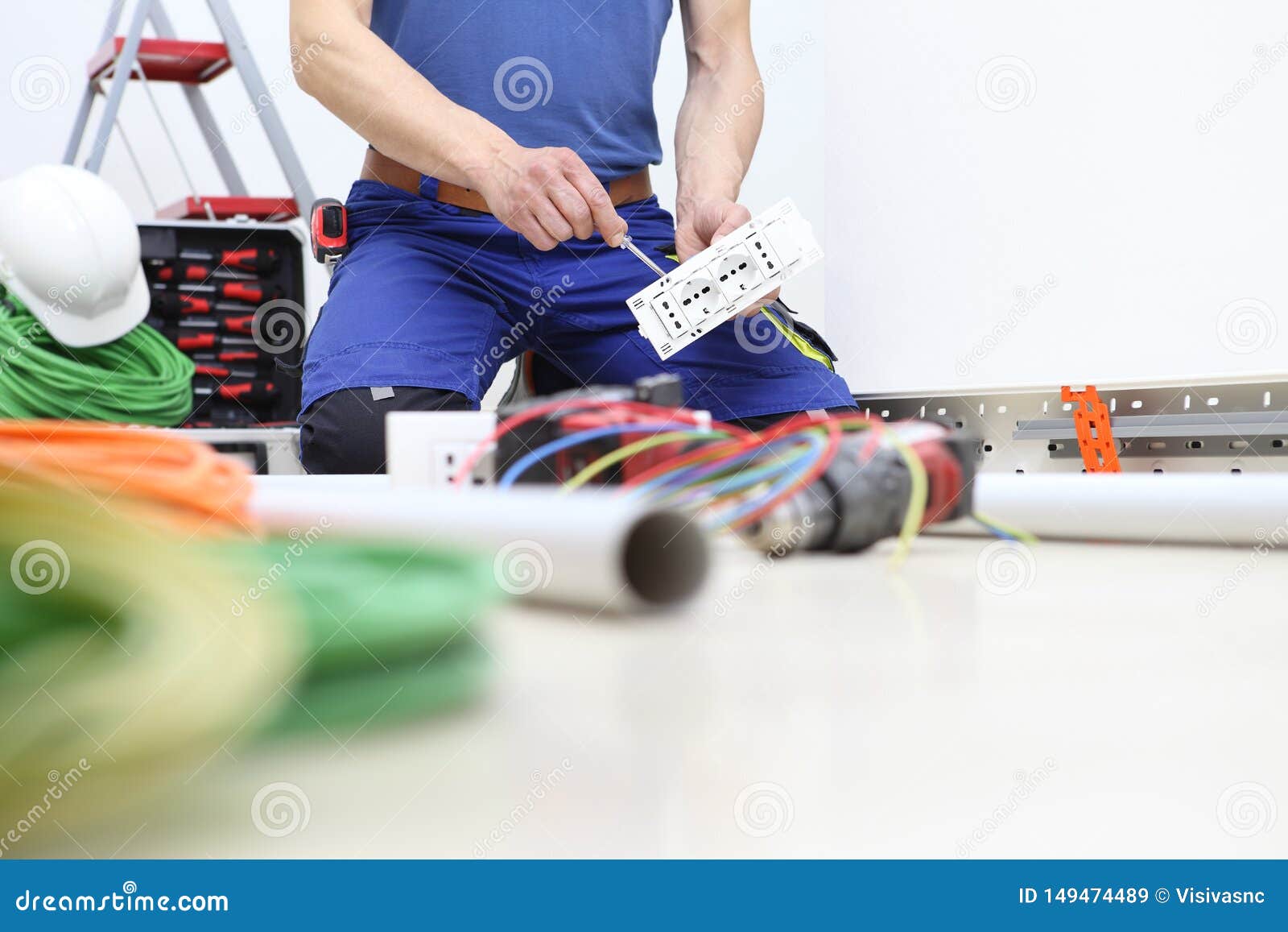 Electrician at Work with Screwdriver in Hand Connects the Cables To the ...