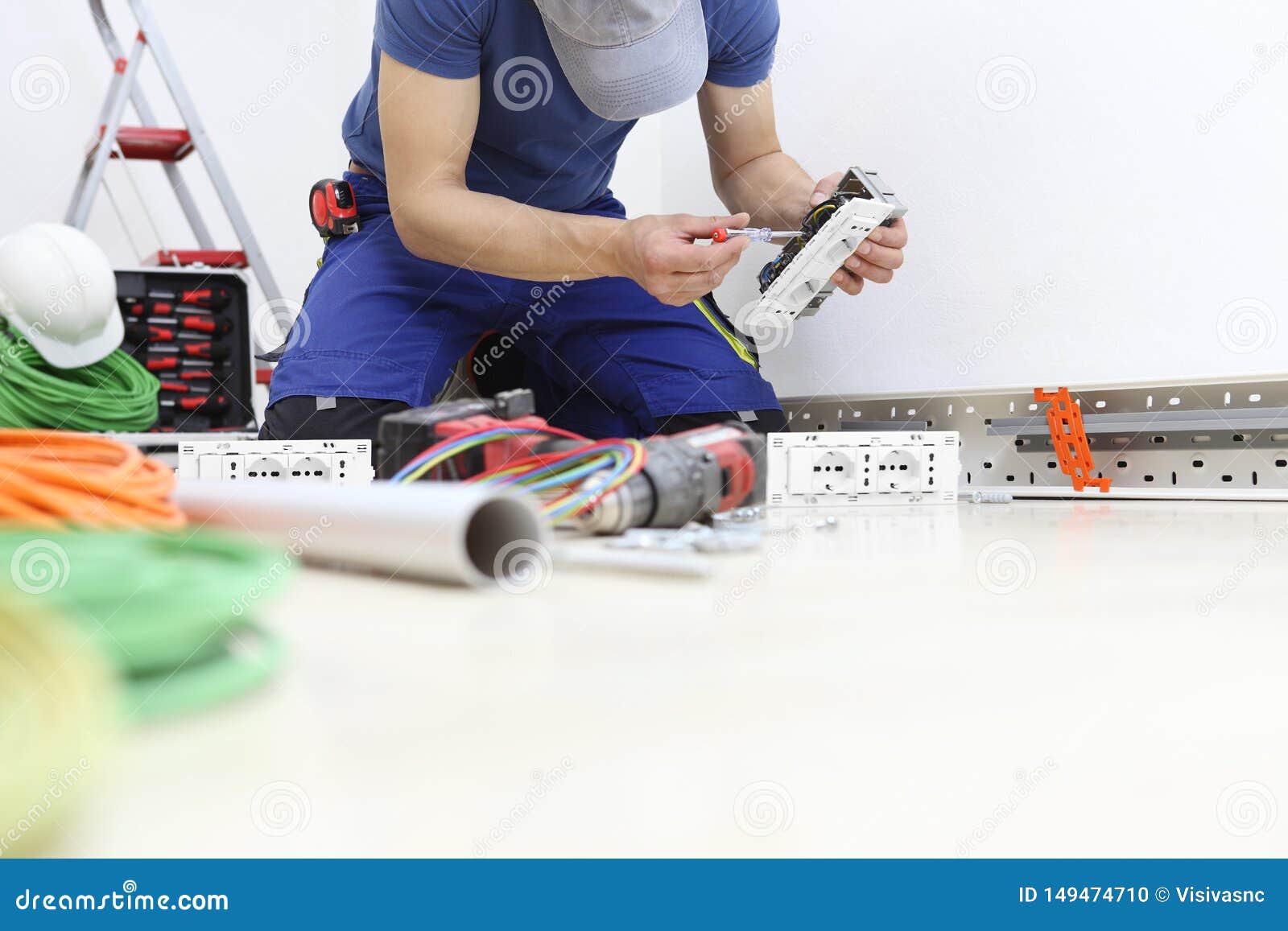 Electrician at Work with Screwdriver in Hand Connects the Cables To the ...