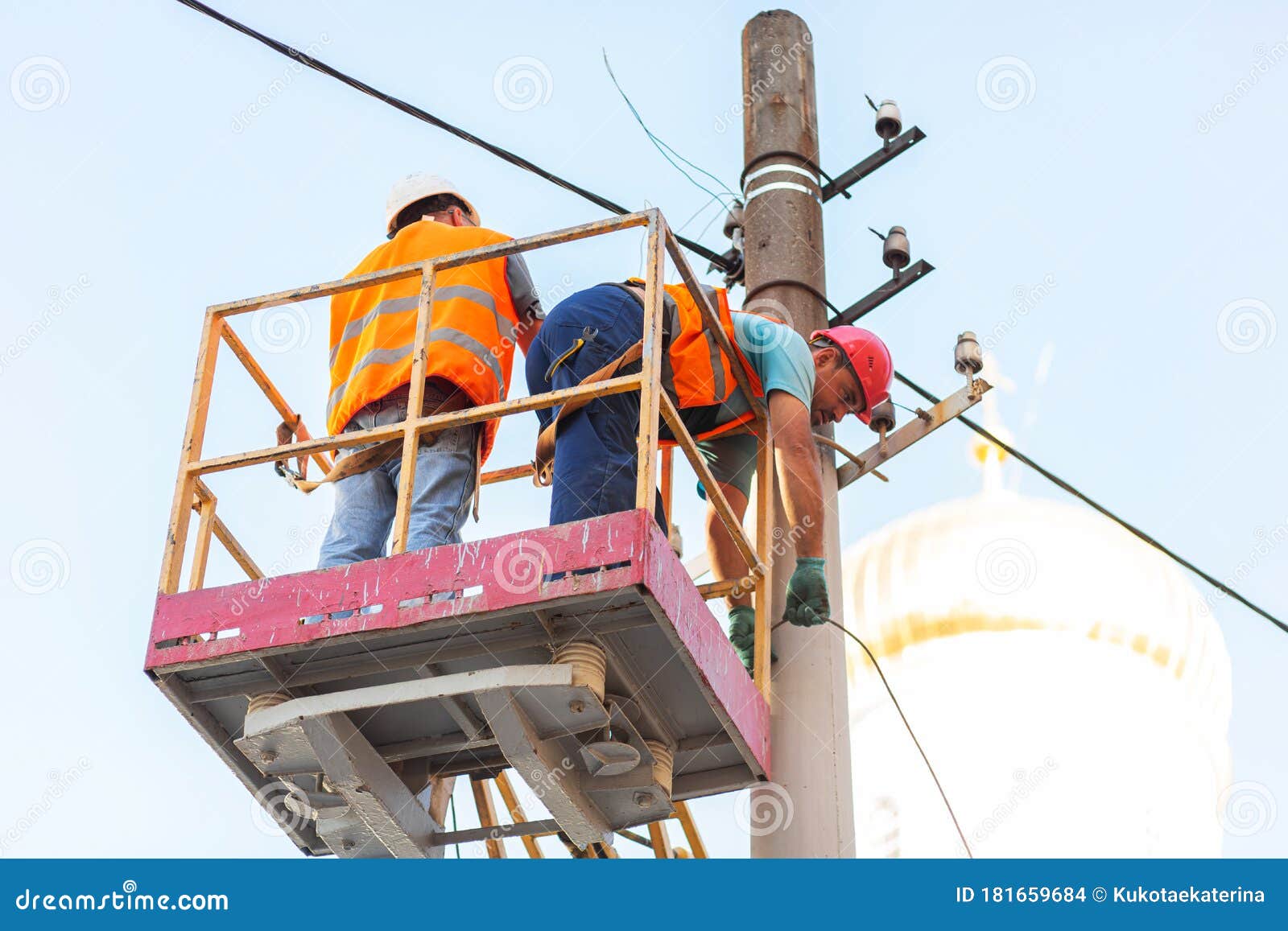 Electricians On The Pillars Install The Mount For The Power Line ...