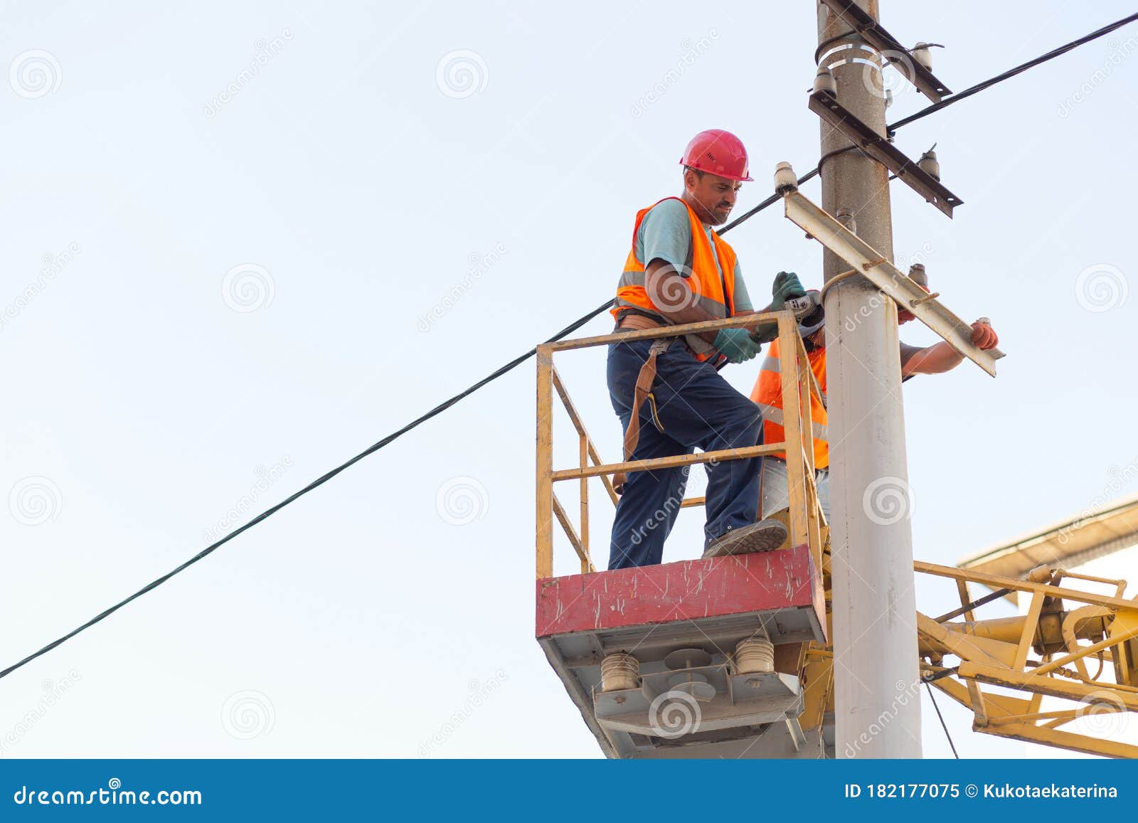Electricians on the Pillars Install the Mount for the Power Line ...