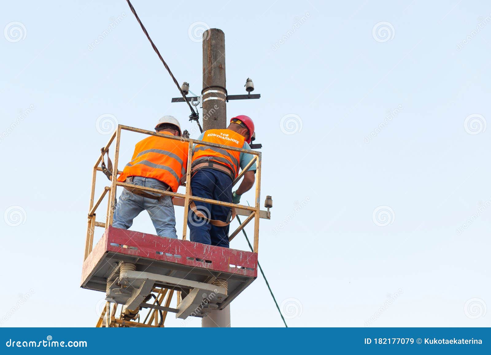 Electricians on the Pillars Install the Mount for the Power Line ...