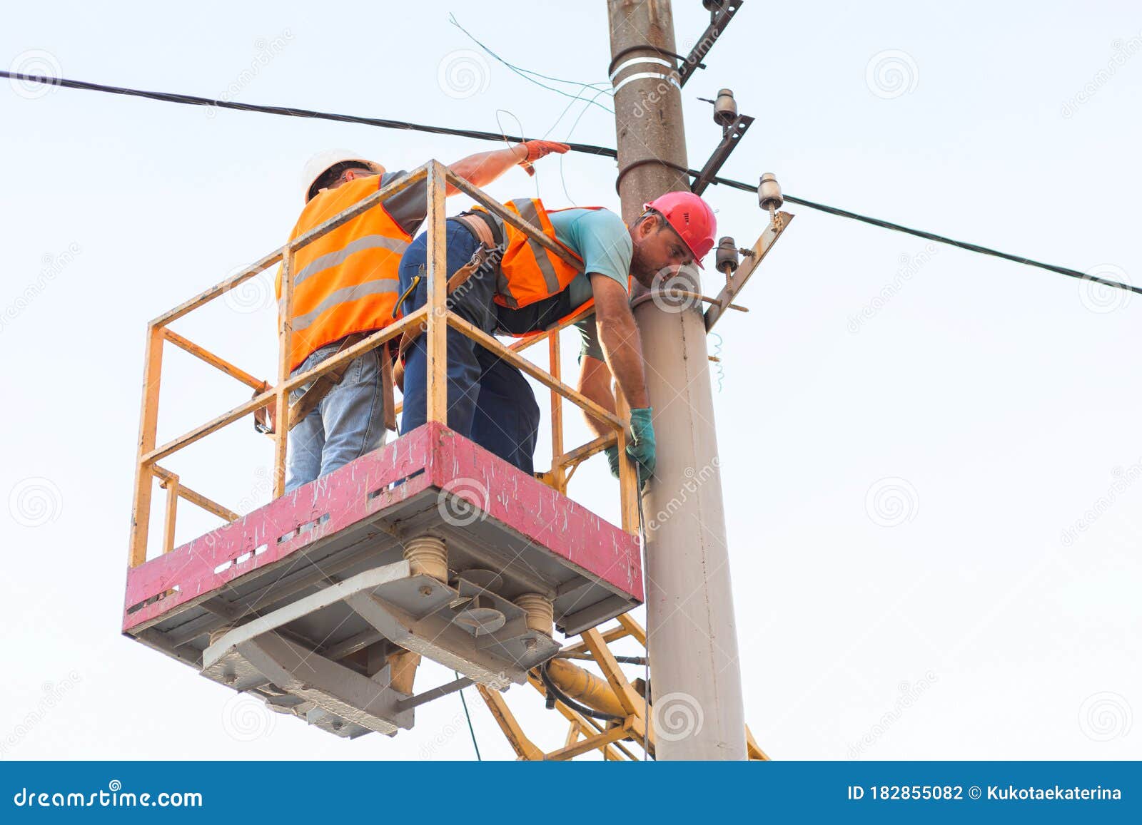 Electricians on the Pillars Install the Mount for the Power Line ...