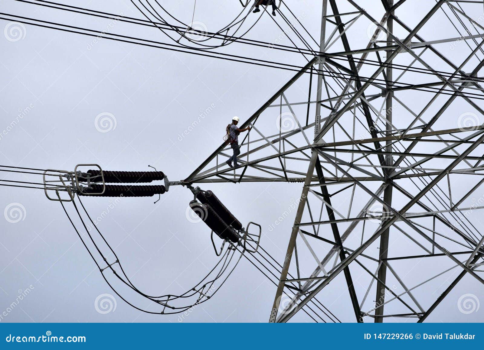 Electricity Board Employee Working in a High Voltage Electric Post ...