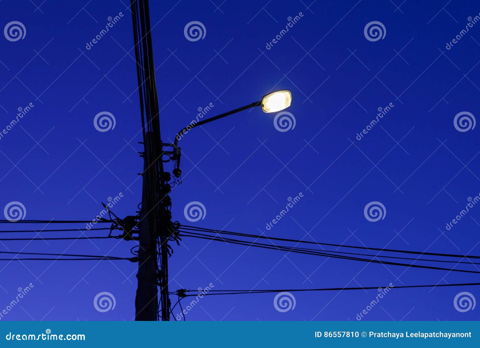 Electricity Post and Cable Line and Street Lamp at Night Stock Photo ...