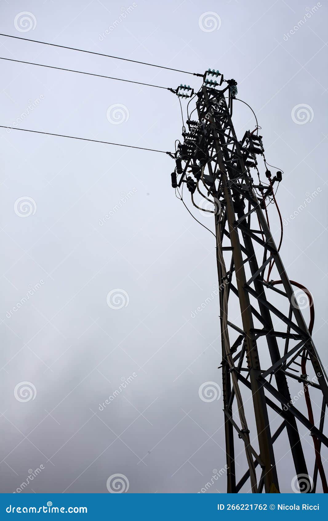 Electricity Pylon with Over Head Cables Passing on it and a Cloudy Sky ...