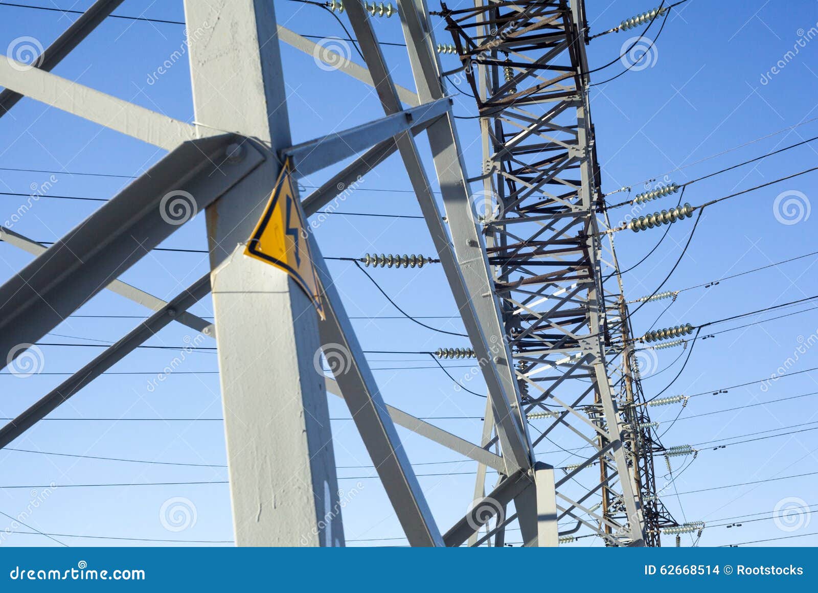Electricity Pylons with Warning High Voltage Sign Stock Photo - Image ...