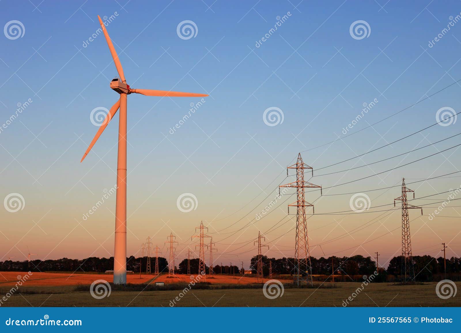 Electricity Pylons and Wind Turbines Against Sky Stock Image - Image of ...