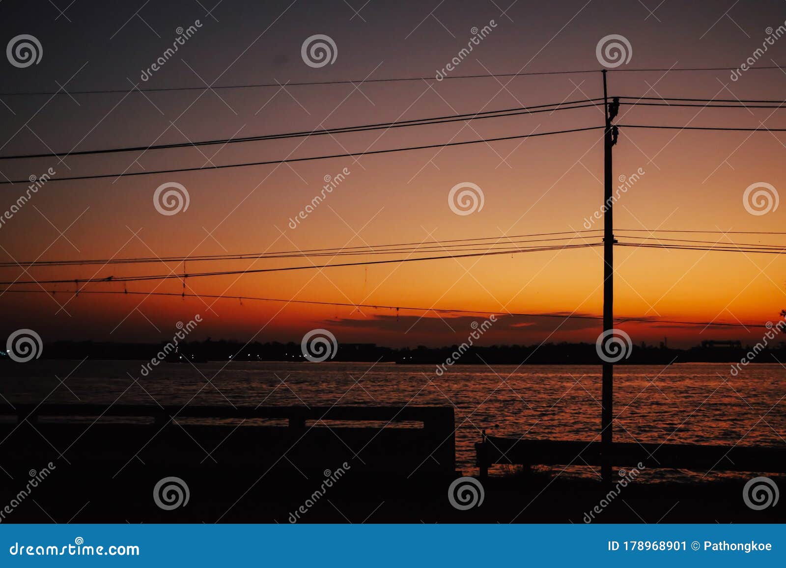 Electricity Pylons with Wire Cable and Street Lamp Post at Sunset Stock ...