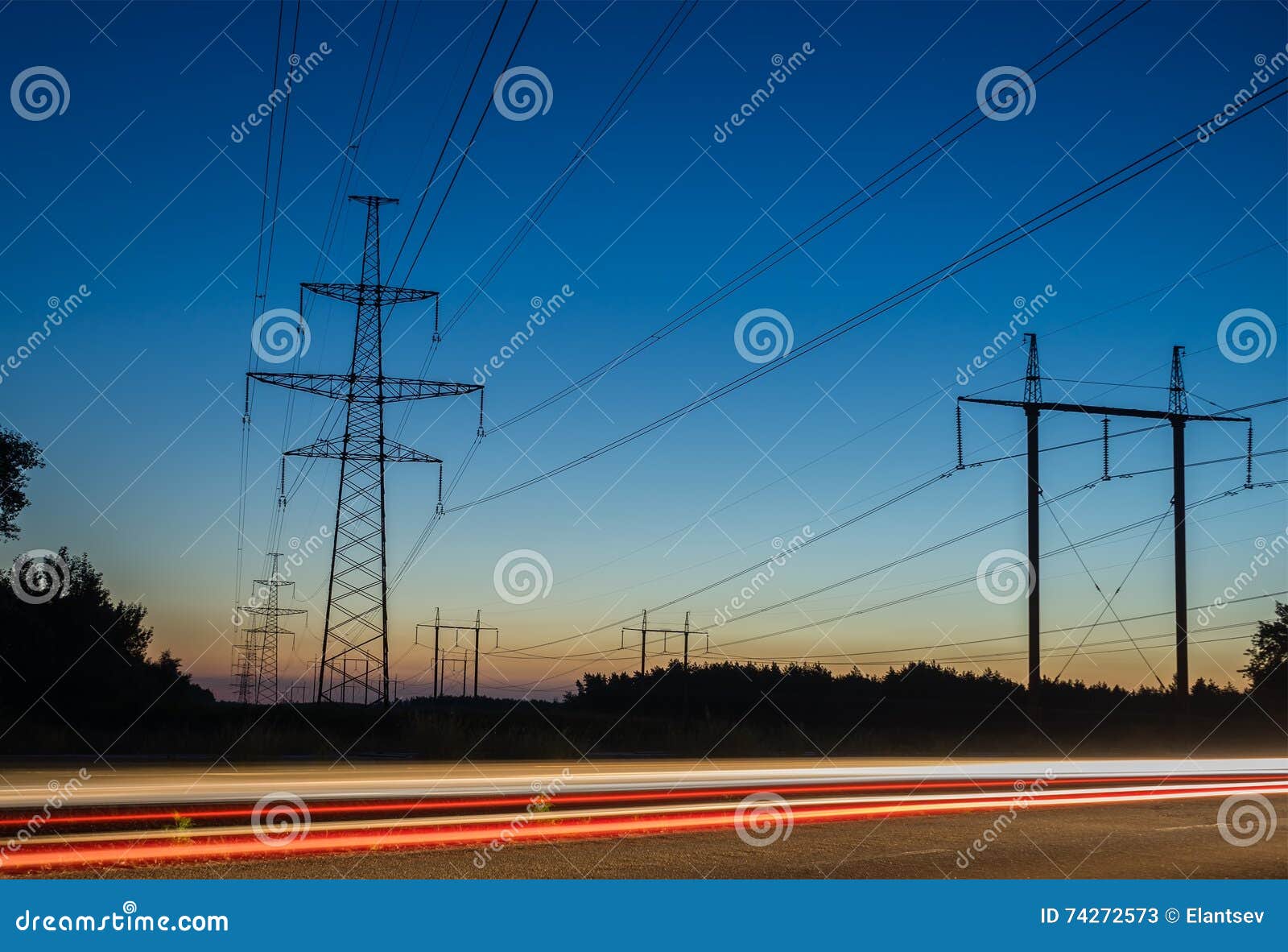 Electricity Transmission Power Lines at Sunset High Voltage Tower ...