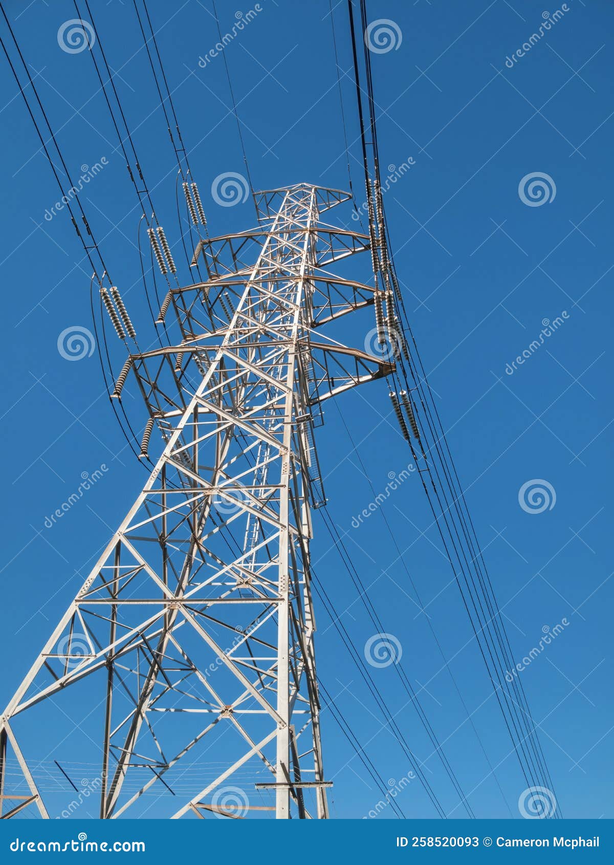 Electricity Transmission Pylon Against Blue Sky Stock Image - Image of ...