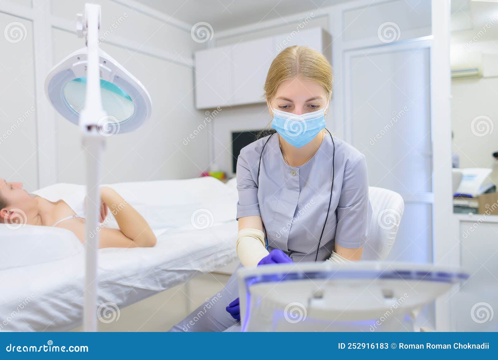 The Electroepilation Master Sits at the Workplace and Sets Up the ...