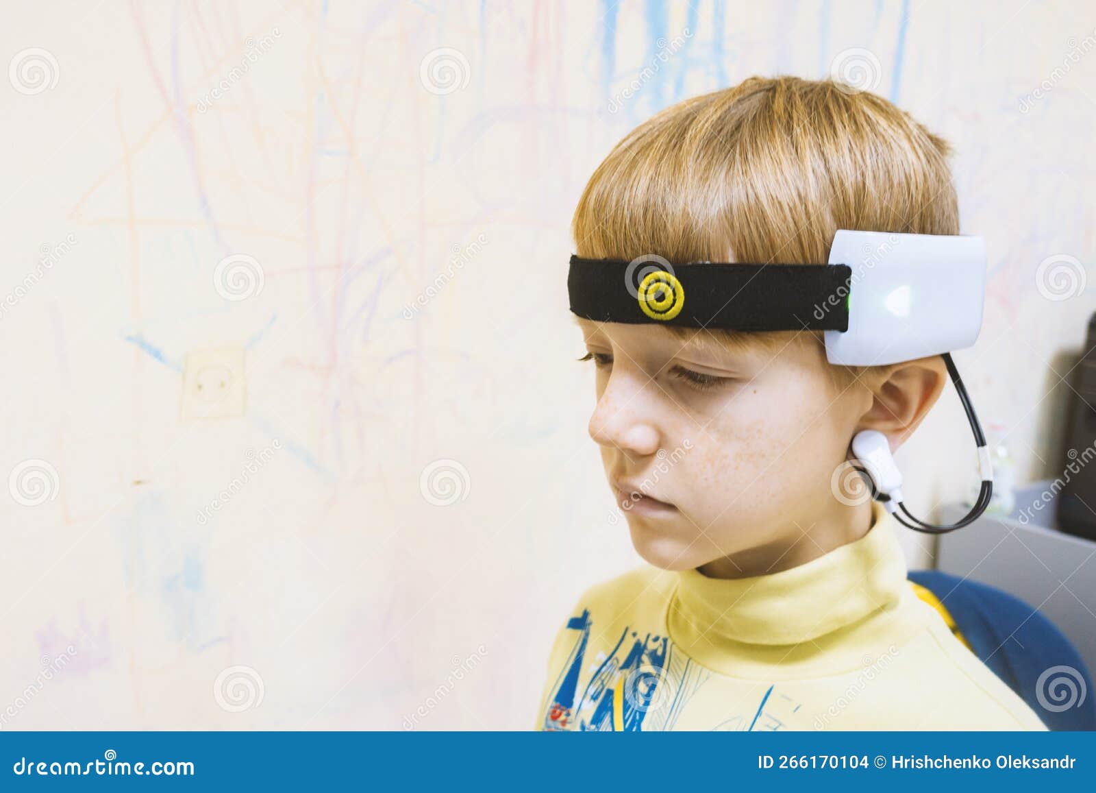 An Electronic Clip Attached To a Child`s Ear To Study Brain Function ...