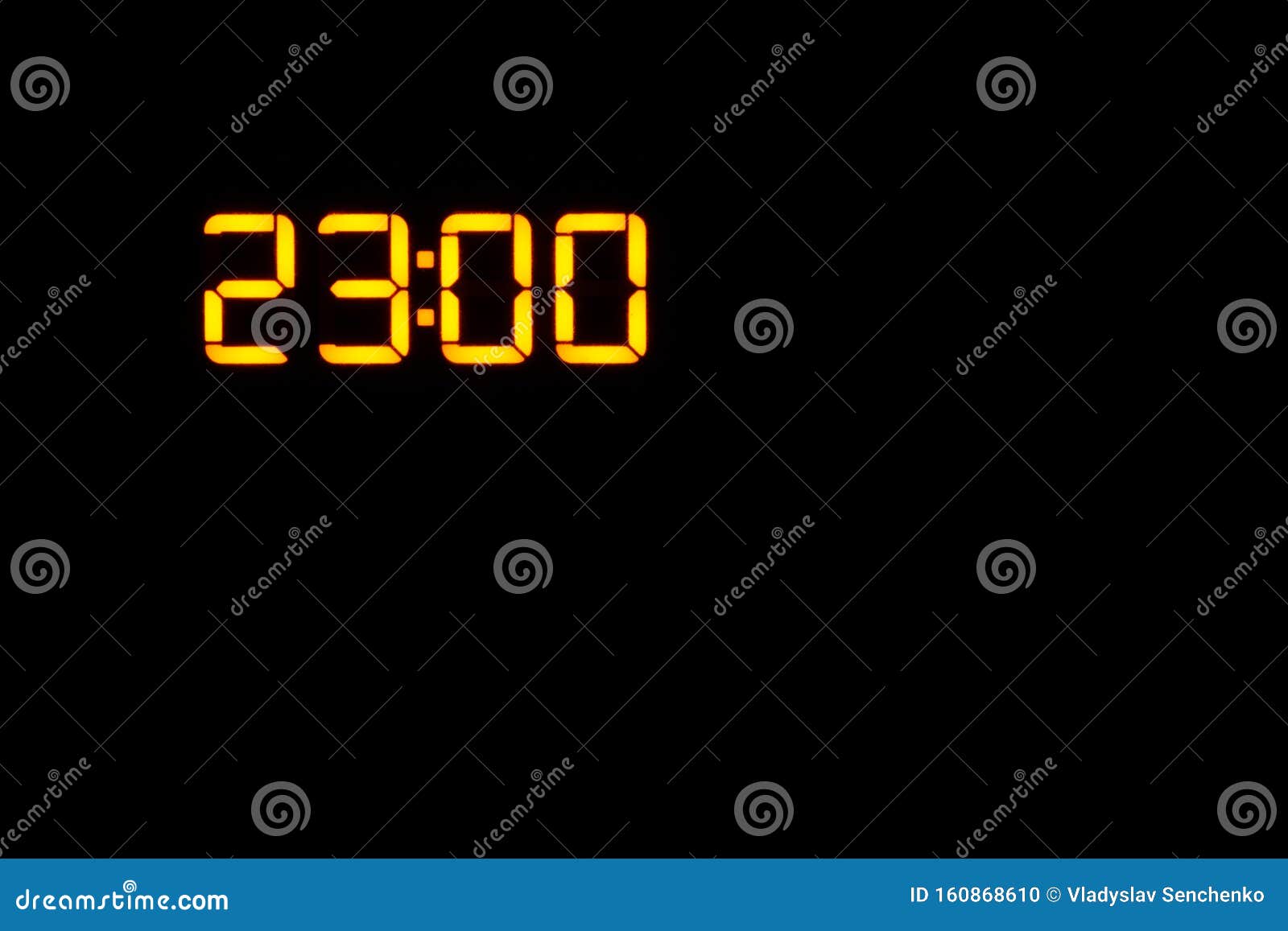 Electronic Clock Showing the Time 23:00 on the Display Orange LEDs on a ...