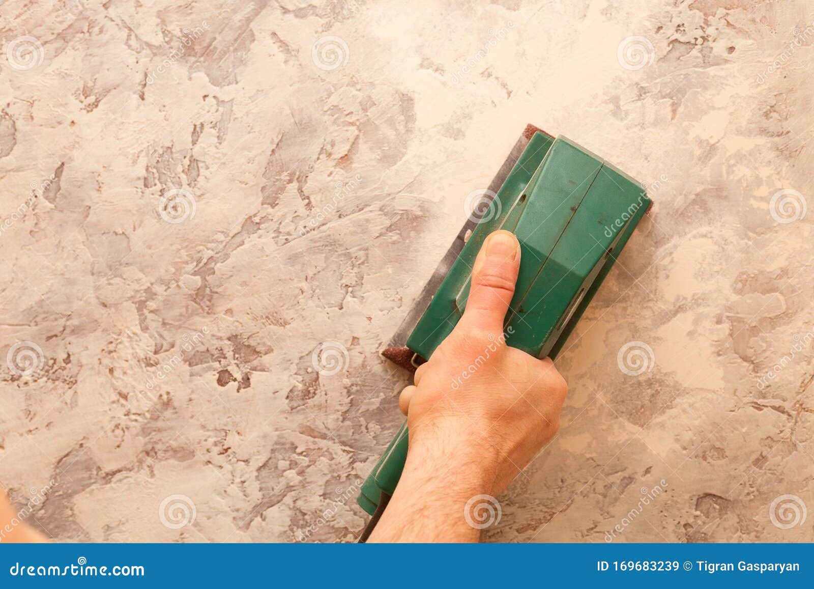 Electronic Grinder in a Hand. Grinding and Leveling the Surface of the ...