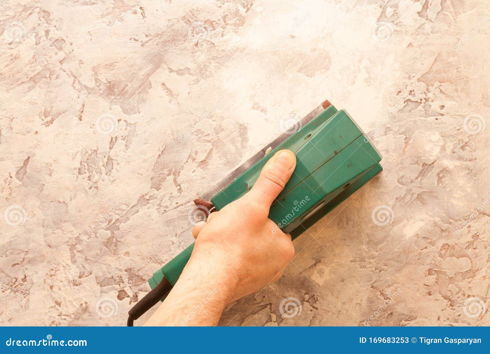 Electronic Grinder in a Hand. Grinding and Leveling the Surface of the ...