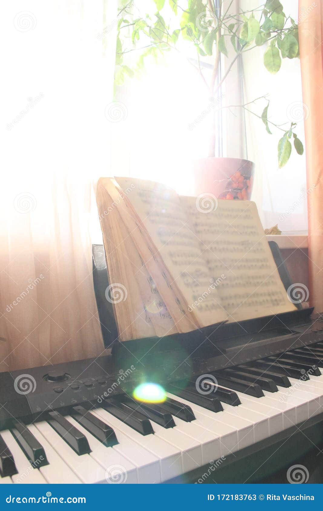 Electronic Piano, Keys and Notes in the Sunlight at the Window ...