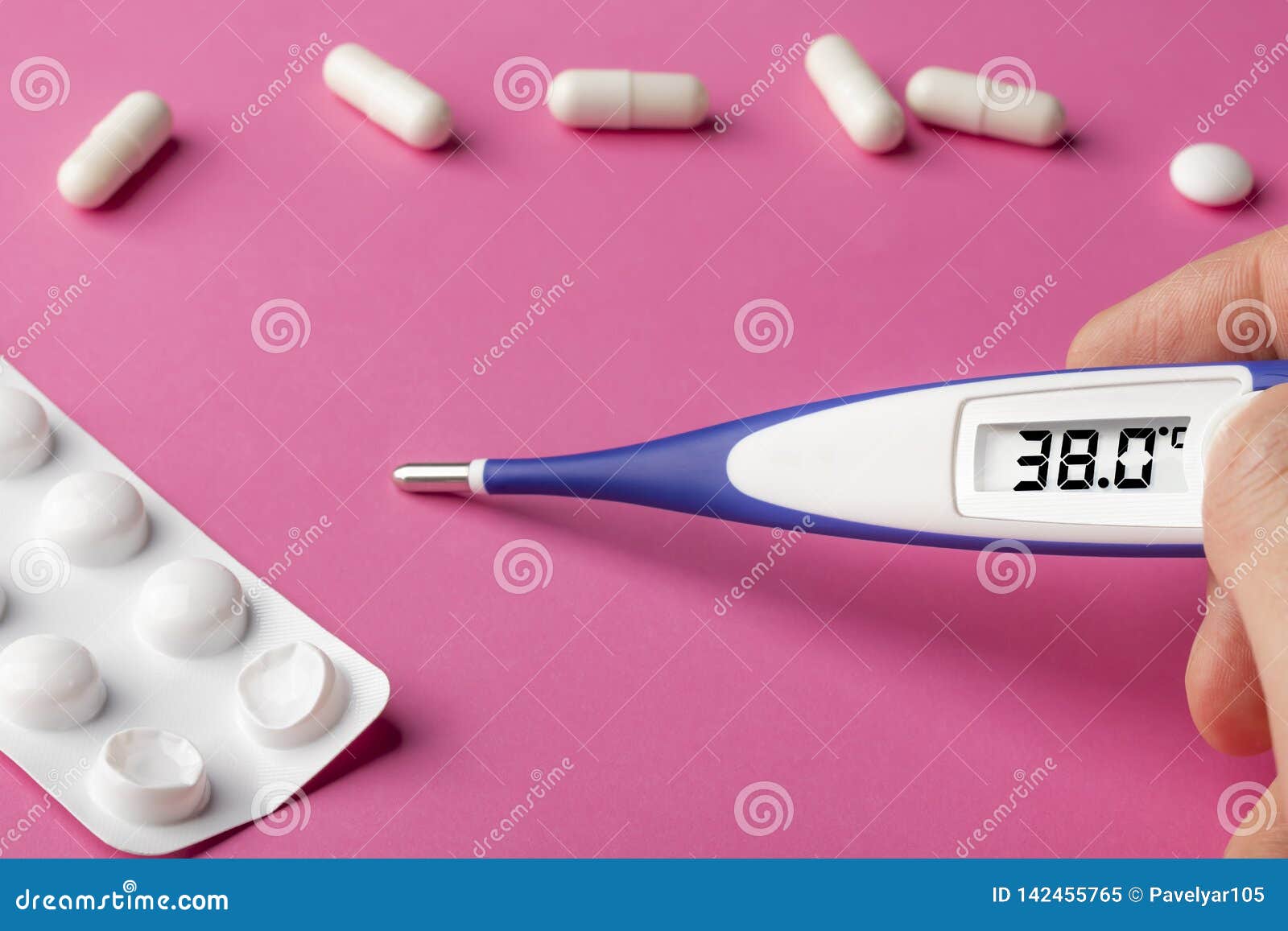 Electronic Thermometer and Pills on a Pink Background. High Temperature ...