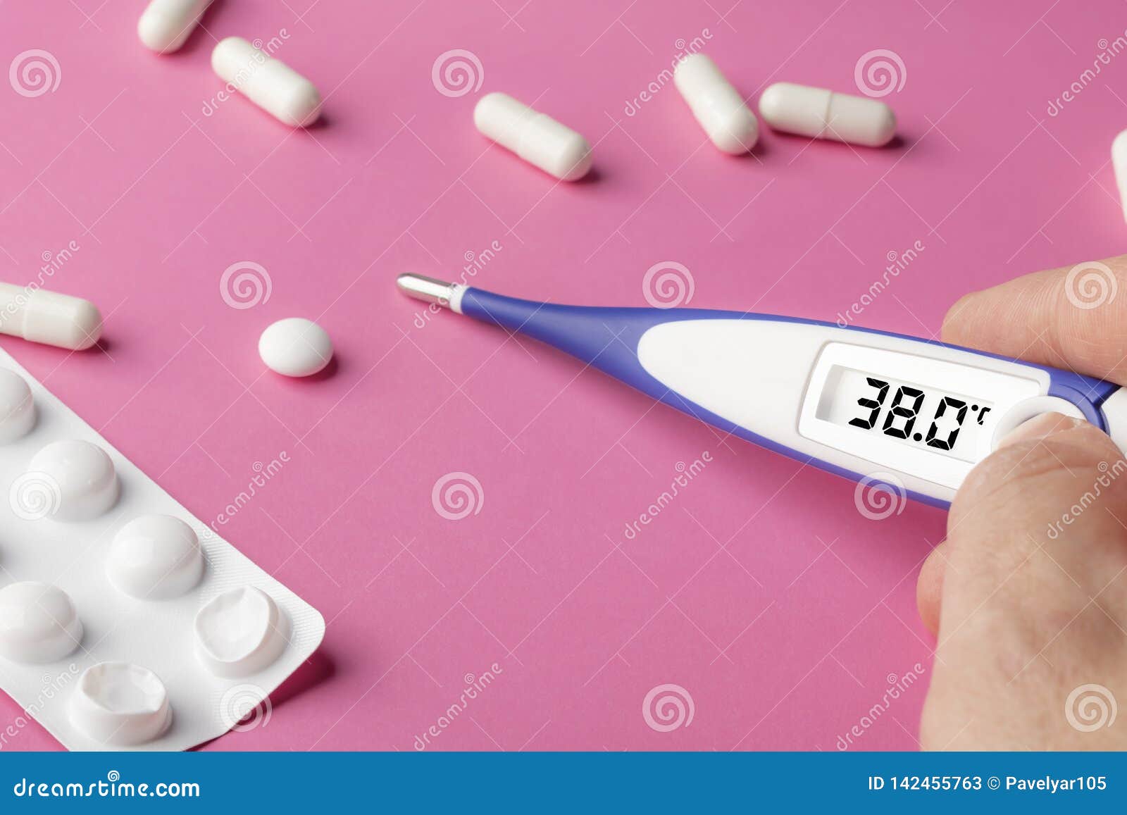 Electronic Thermometer and Pills on a Pink Background. High Temperature ...