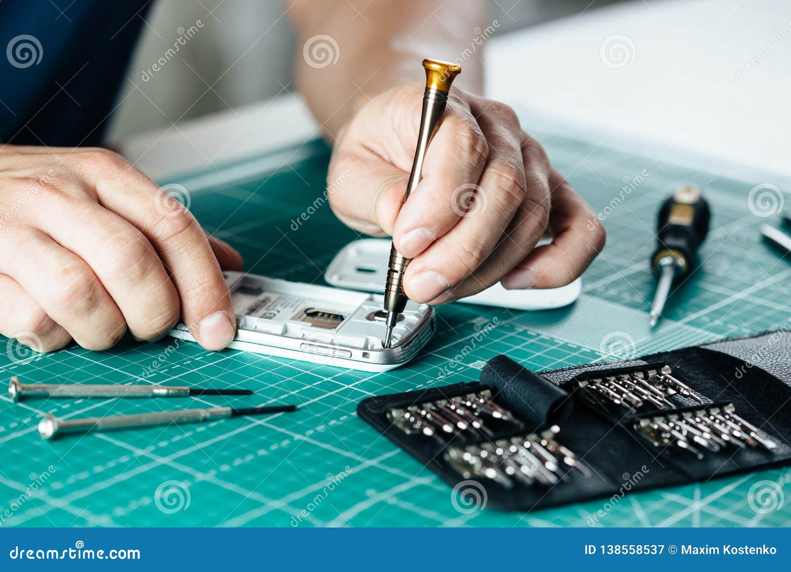 Electronics Repair Service. Technician Disassembling Smartphone for ...