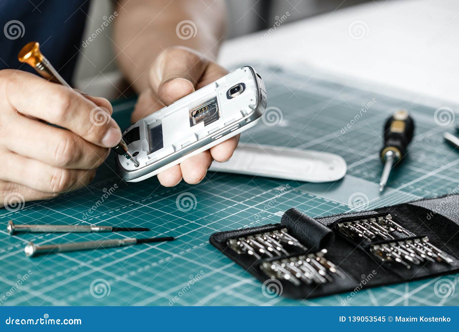 Electronics Repair Service. Technician Disassembling Smartphone for ...