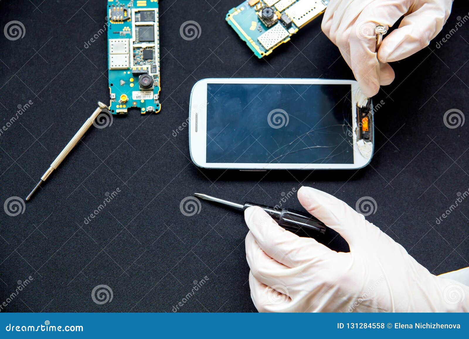 Electronics Repair Service - Technician is Fixing Broken Cell Phone ...